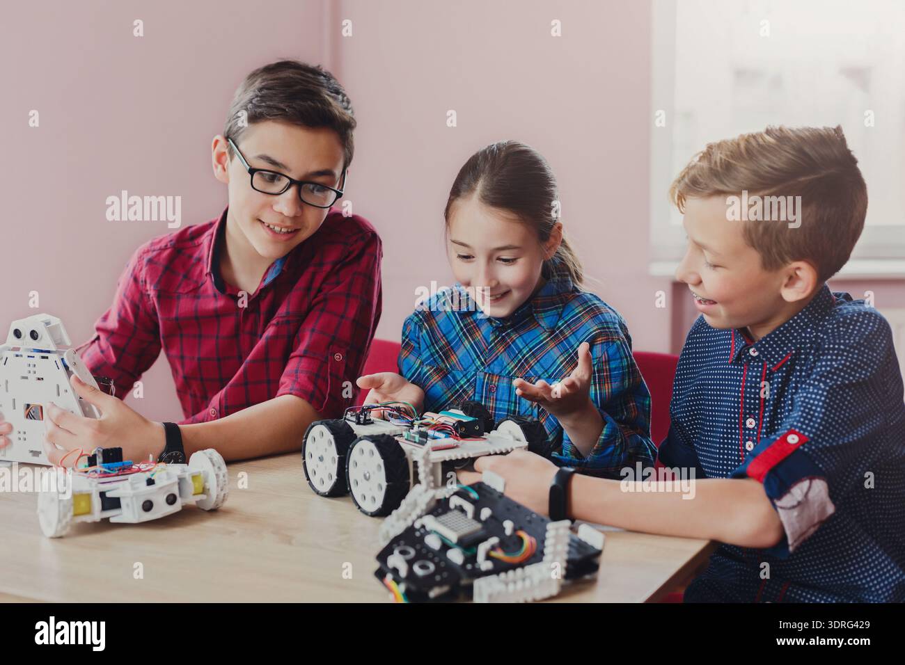 Stem education. Children building robots in classroom Stock Photo - Alamy