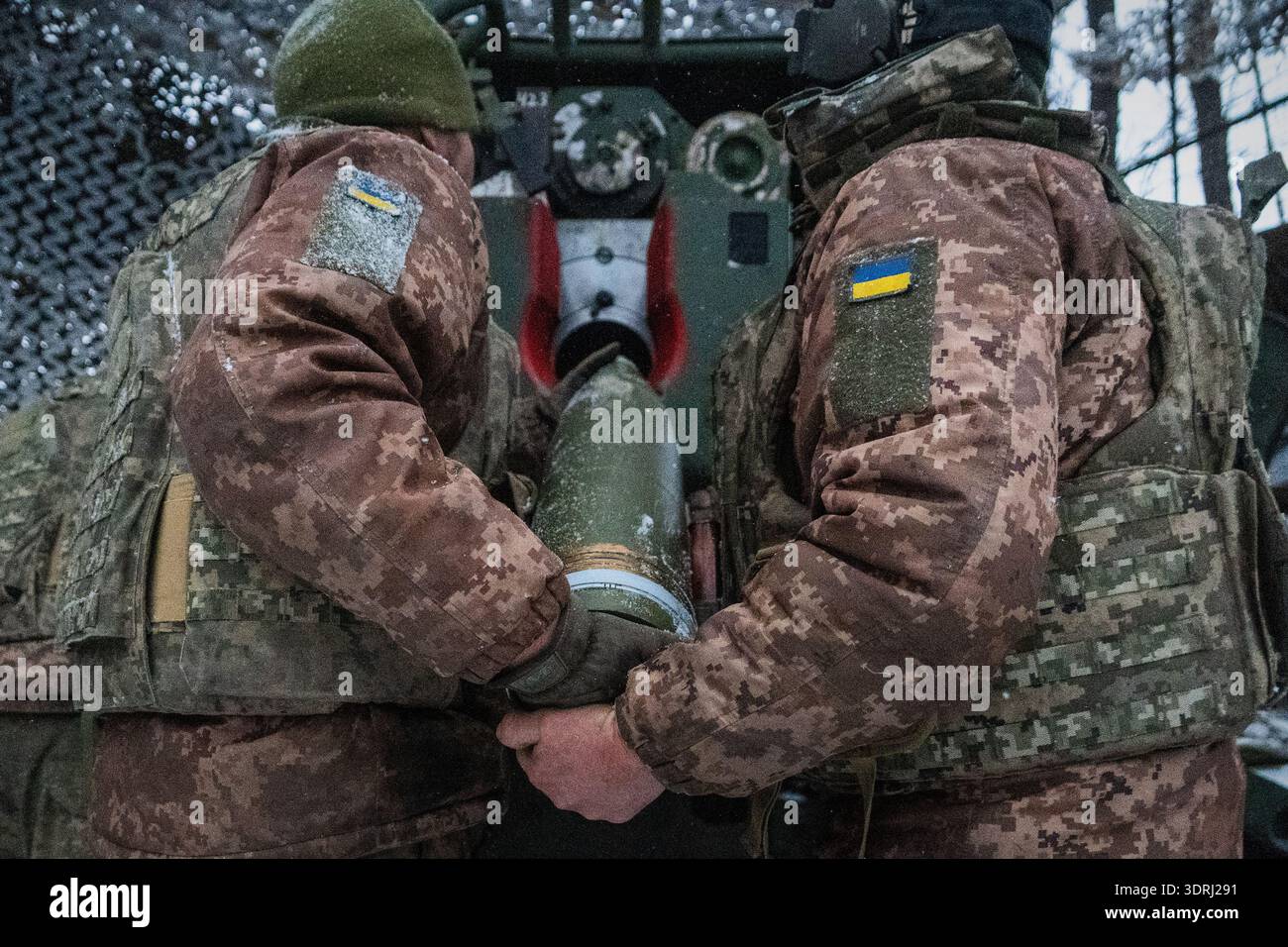 Ukrainian servicemen of the 48th separate artillery brigade load an ...