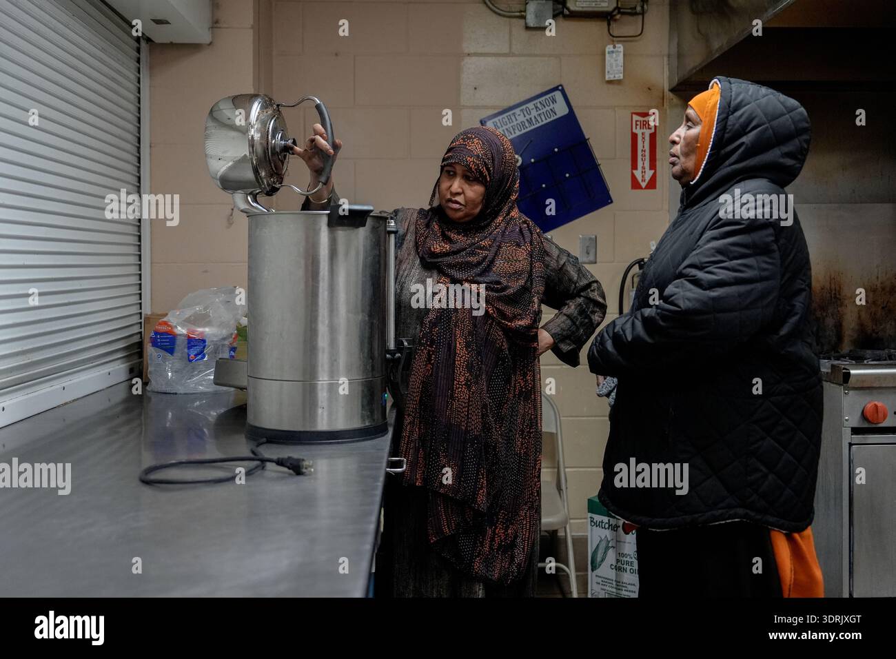 Nasro Hassen pours shaah, Somali spiced tea, as Halimo Mohamed watches ...