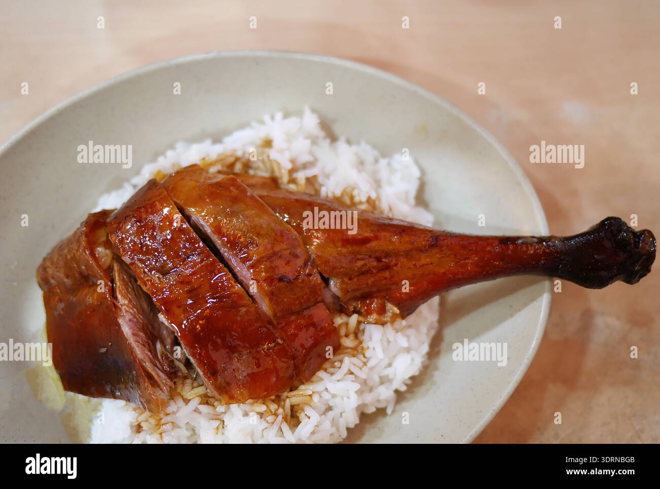 Hong Kong roasted goose drumstick served over steamed jasmine rice ...