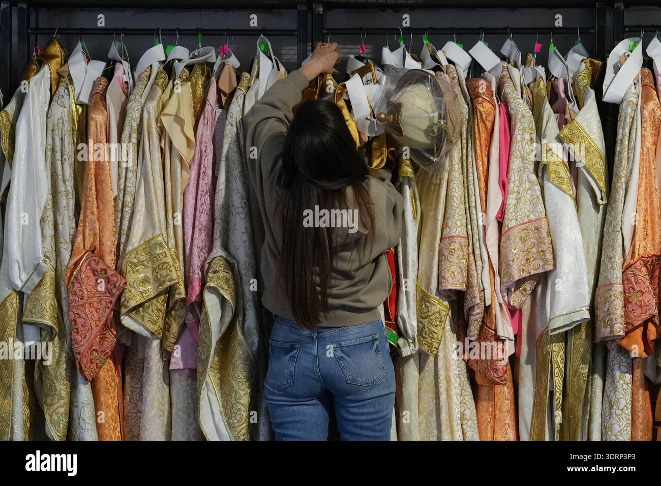 Dressmaker Luciana Donadio works in a dressing room, outside the Arena ...
