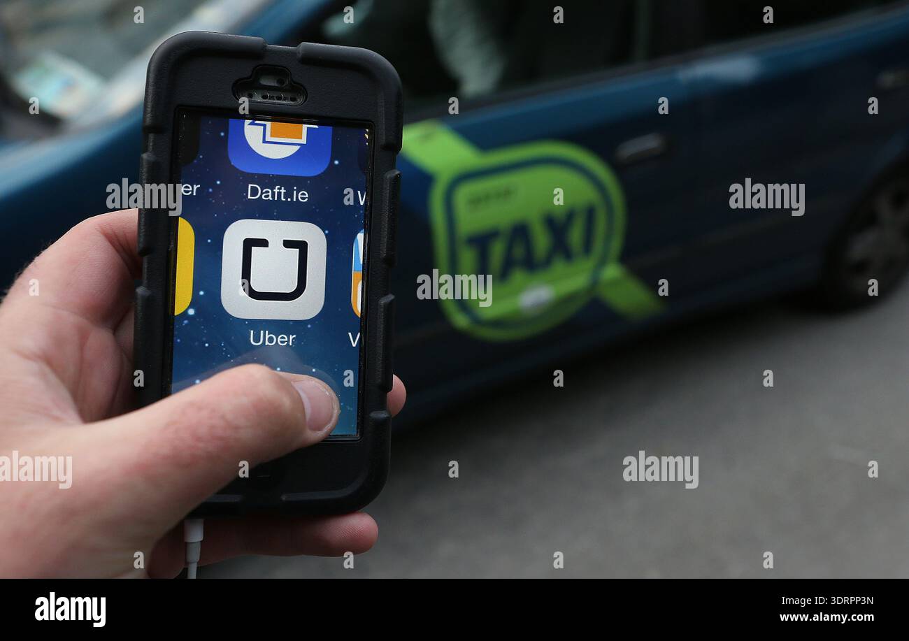 File photo dated 01/05/14 of the Uber mobile phone app in use at a taxi ...