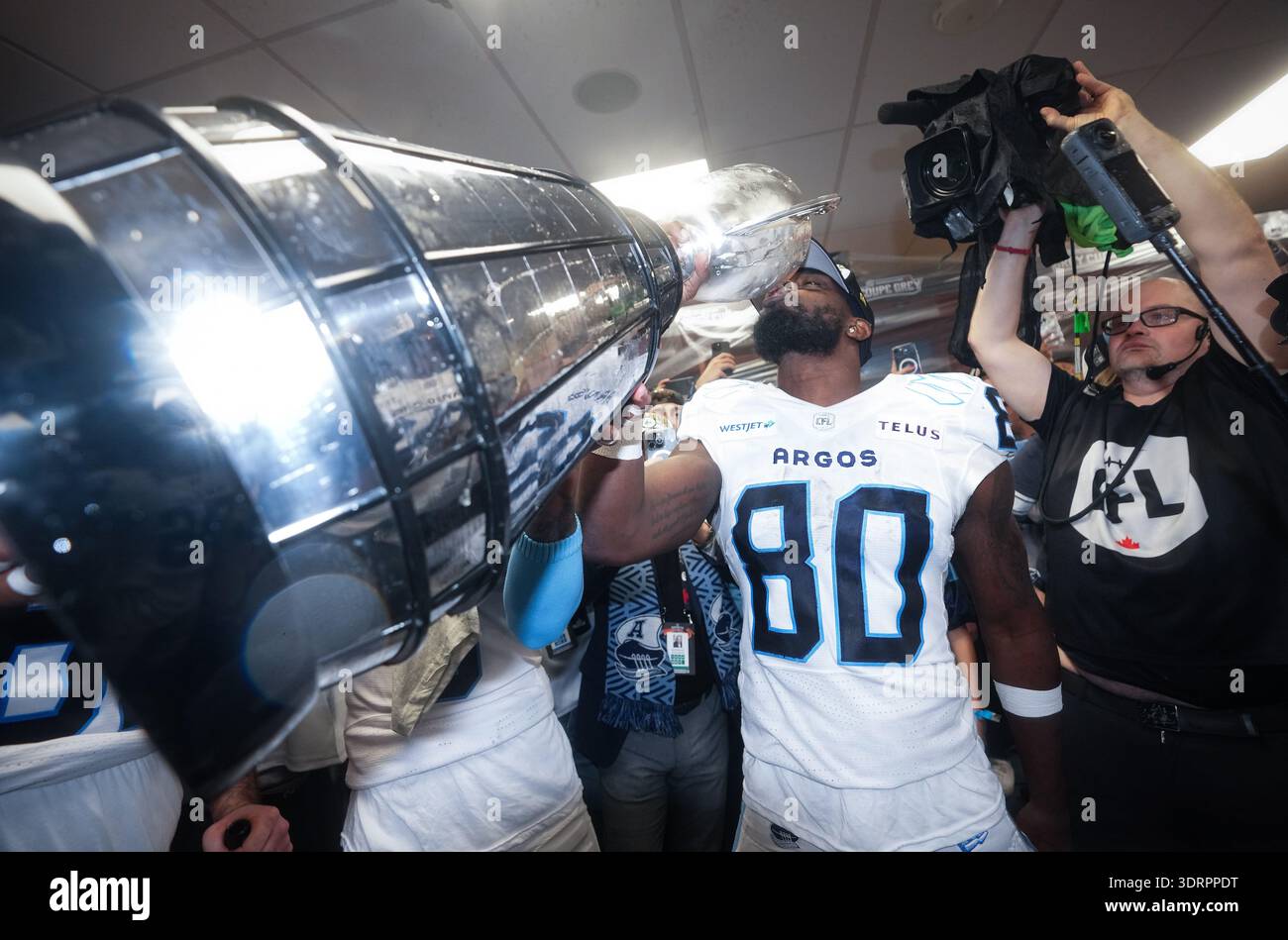 Toronto Argonauts' DaVaris Daniels drinks from the Grey Cup trophy ...