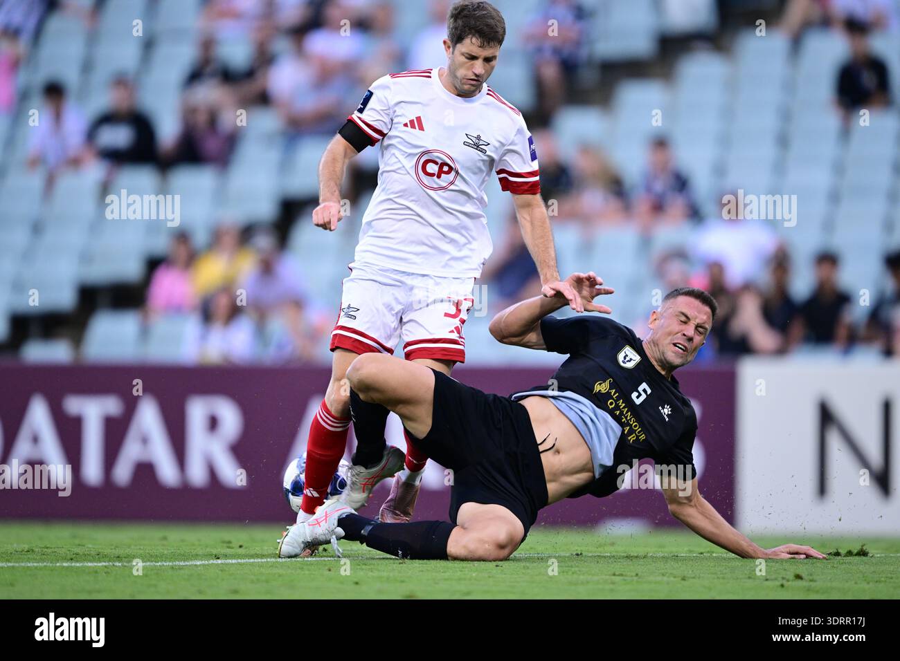 Matthew Jurman of Macarthur tackles Nebojsa Kosovic of Bangkok during ...