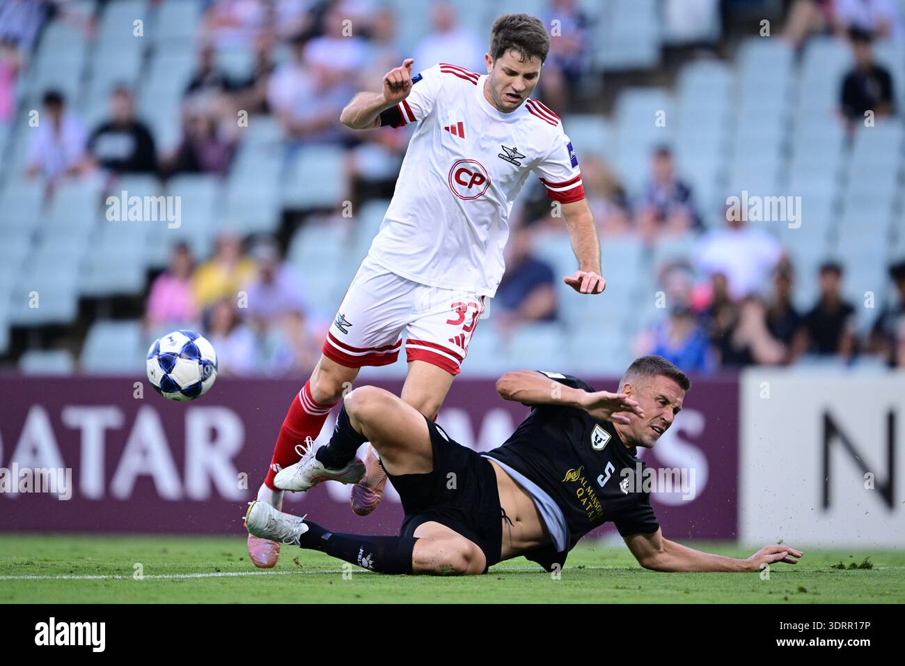Matthew Jurman of Macarthur tackles Nebojsa Kosovic of Bangkok during ...