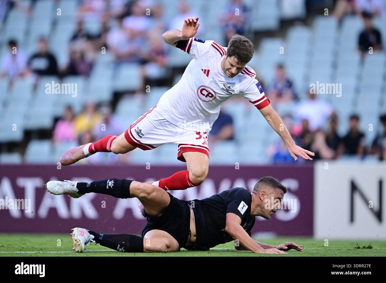 Matthew Jurman of Macarthur tackles Nebojsa Kosovic of Bangkok during ...