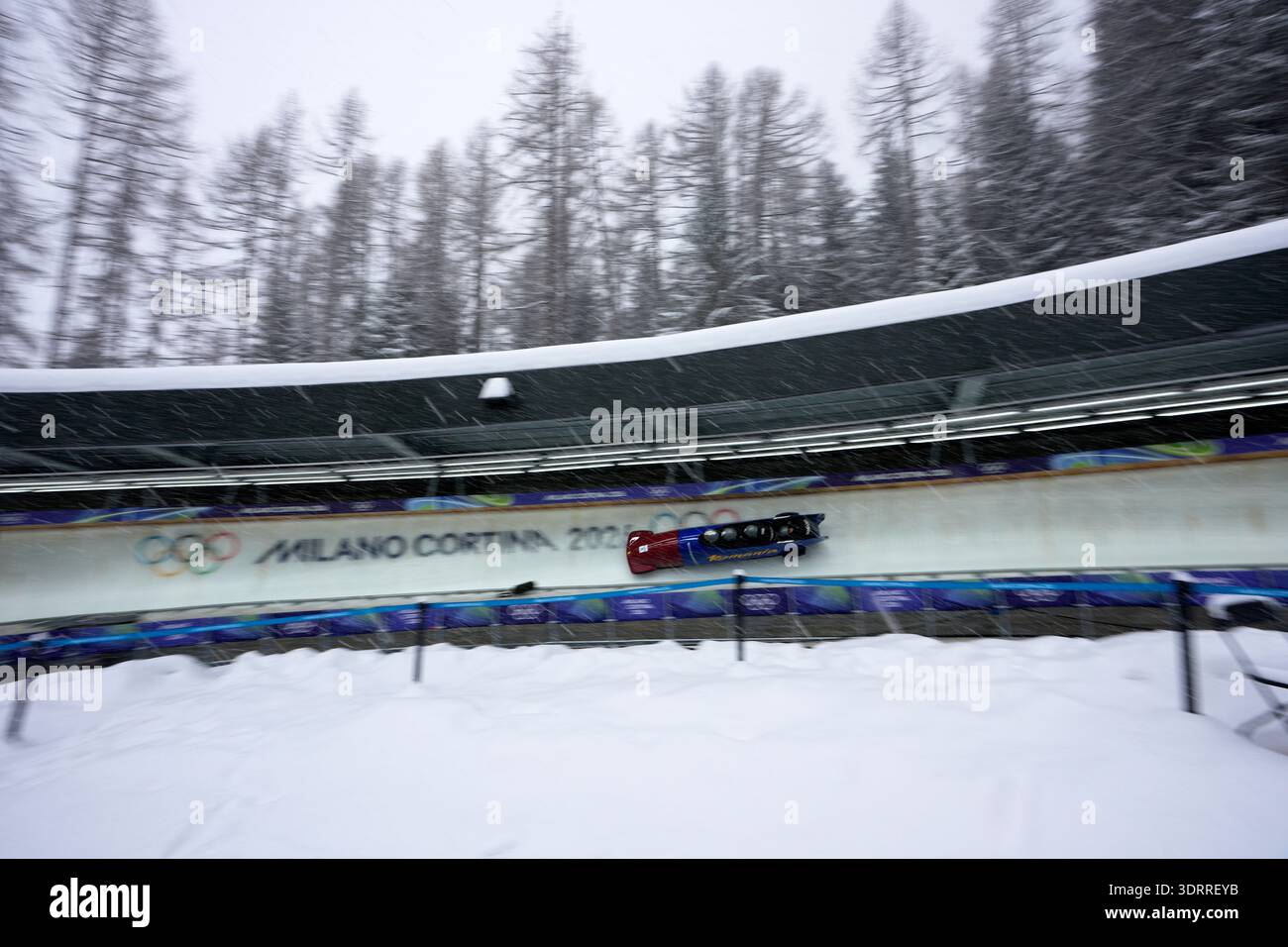 Romania's Mihai Cristian Tentea, left, slides down the track during a ...