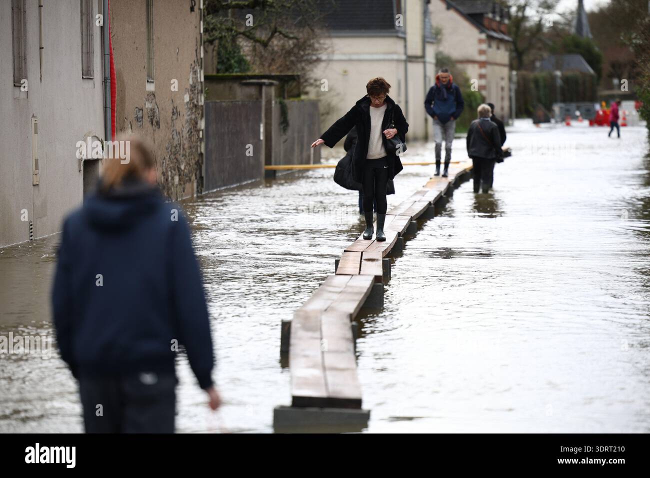 Inhabitants pictured during flooding of the Maine River at the mouth of ...
