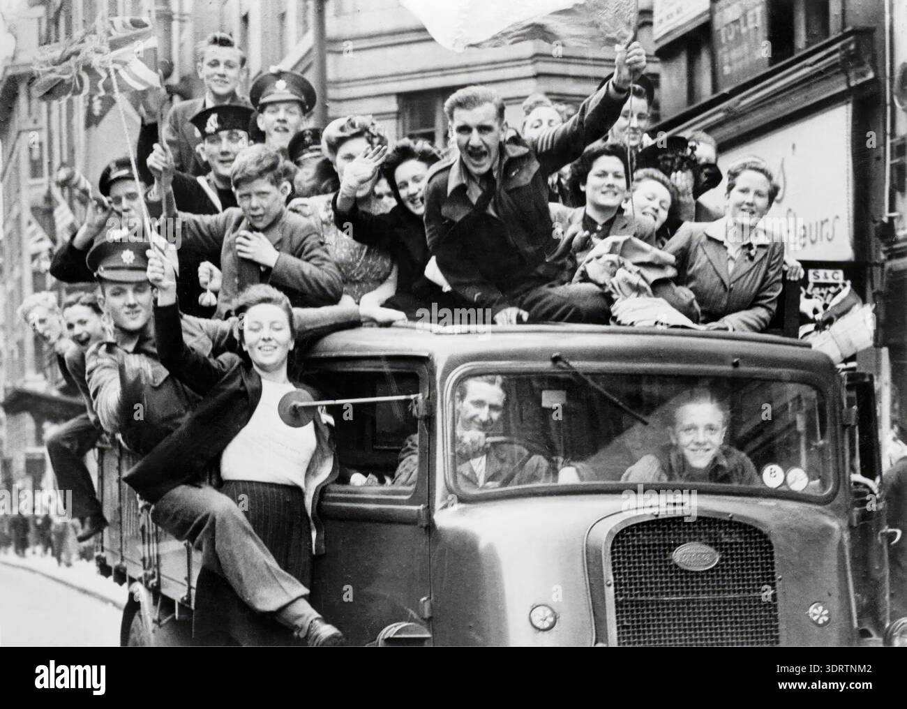 8 May 1945. A lorry load of people travelling along the Strand in ...