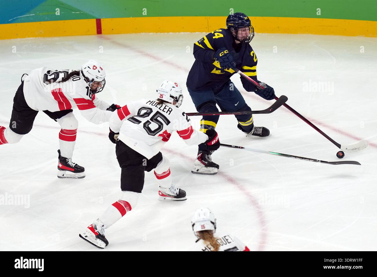 Sweden's Ebba Hedqvist (24) moves the puck as she is defended by ...
