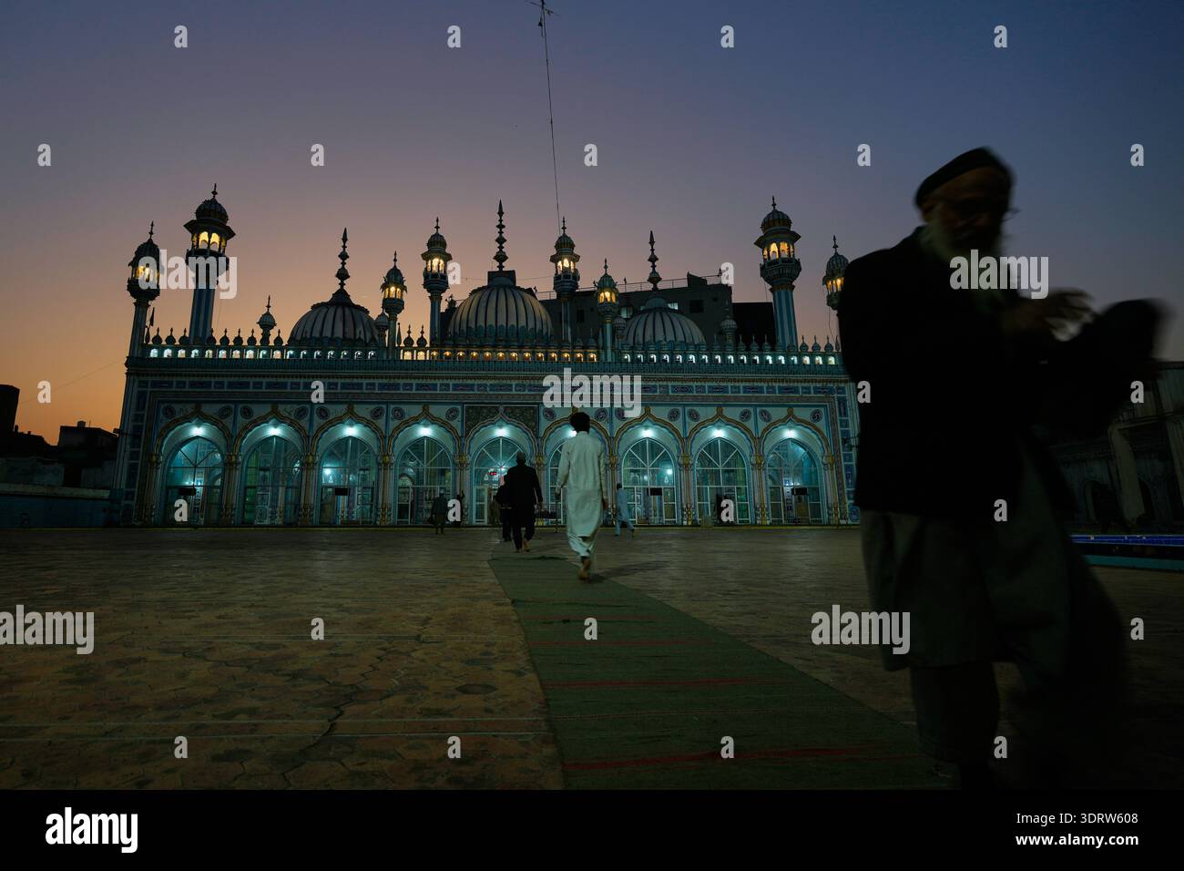 People leave a mosque after breaking fast and evening prayers during ...