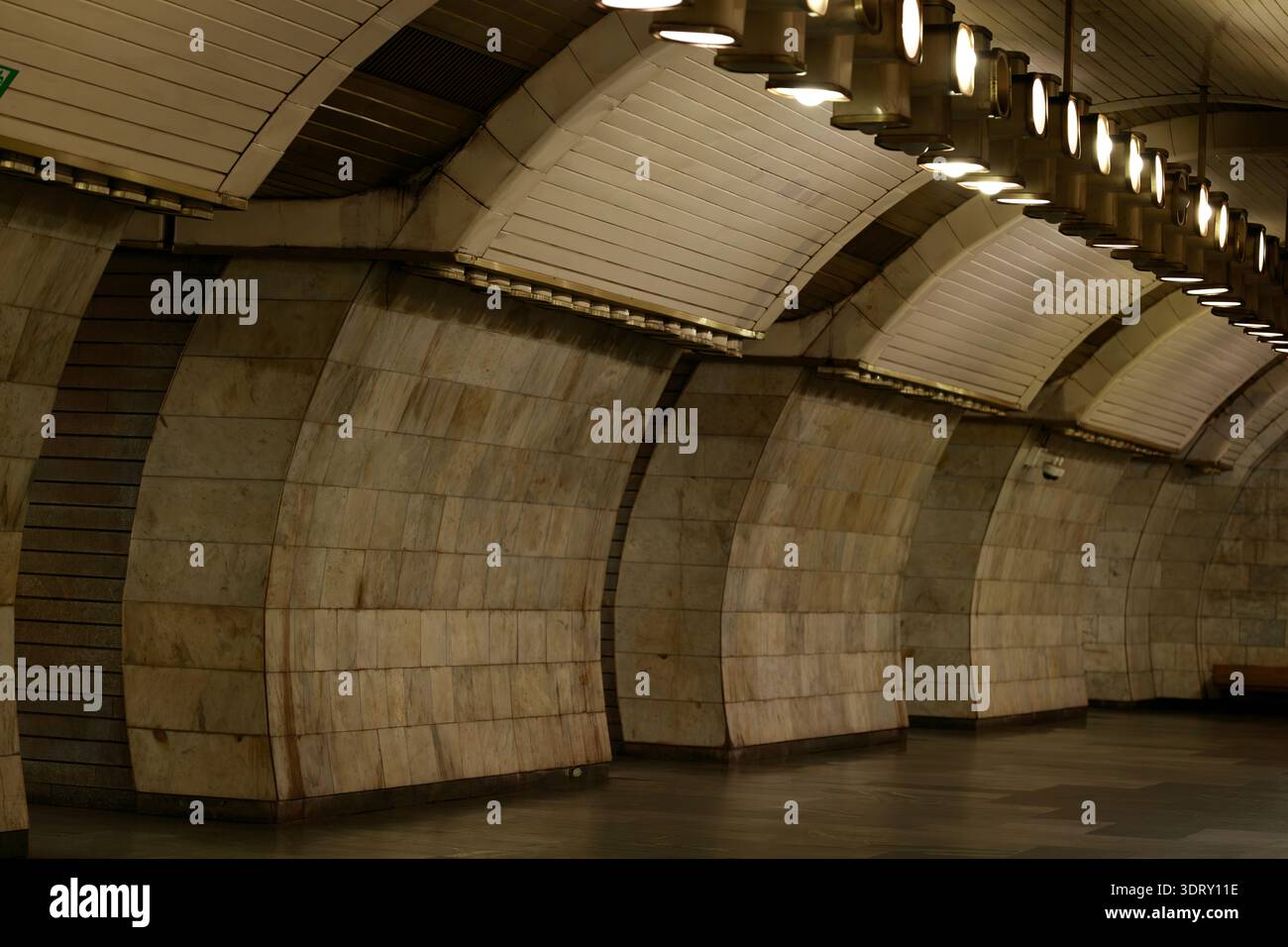 The interior of a vintage subway station features curved marble walls ...
