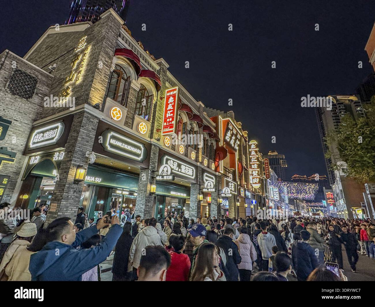 People tour Zhongshan Road, a shopping street, in Nanning in southern ...