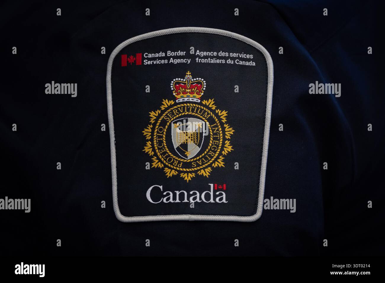 A Canada Border Services Agency patch is worn on an officer at RCMP "E ...