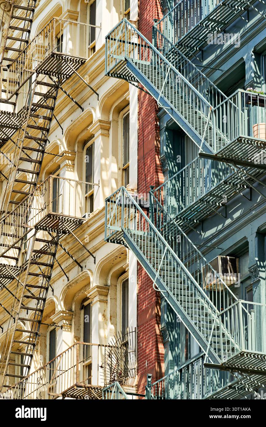 Two buildings in Manhattan show different fire escape stairs. The metal ...