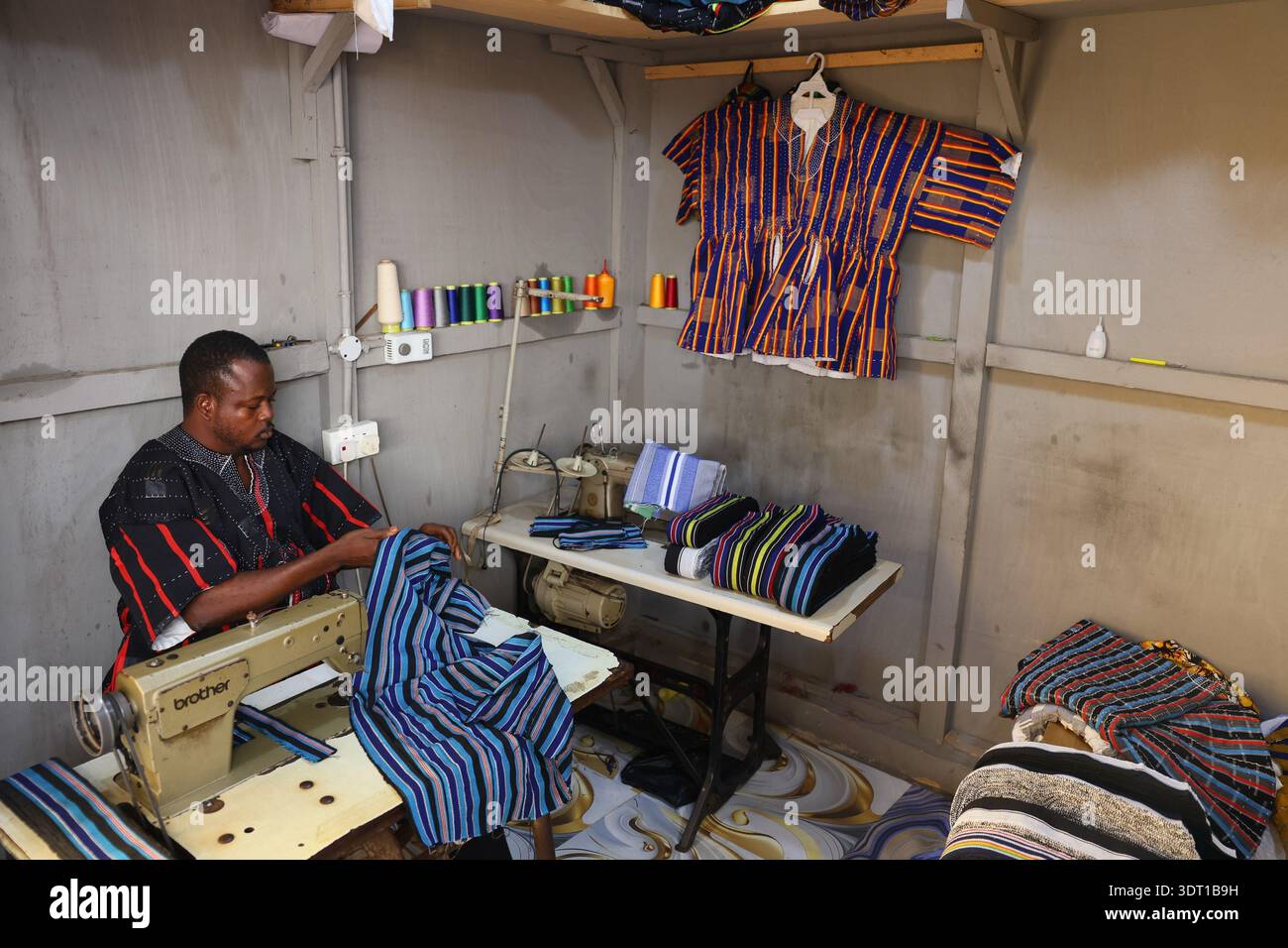 Moses Adibasa, a traditional fugu garment maker, works on in his ...