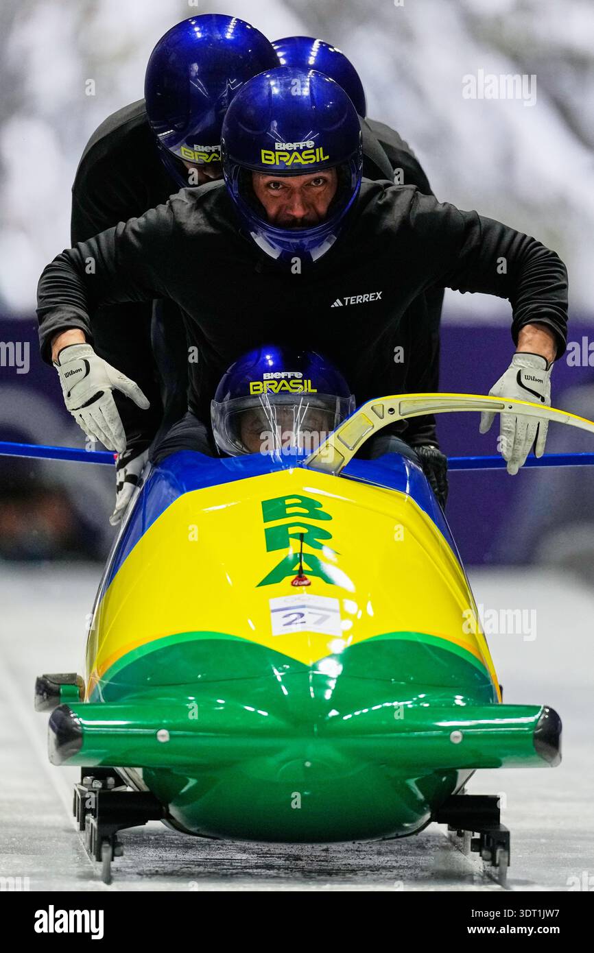 Brazil's Edson Luques Bindilatti, front, starts for a four man bobsled ...