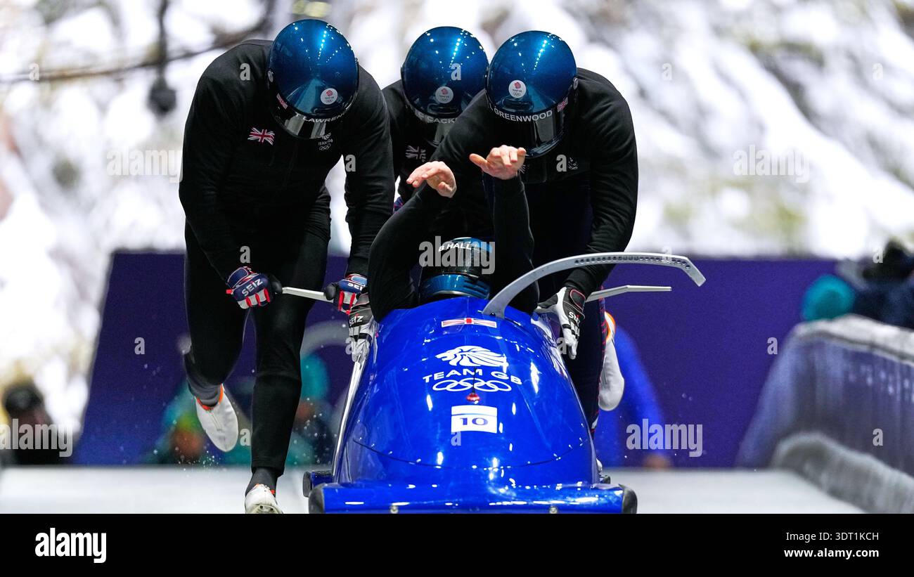 Britain's Brad Hall, front, starts for a four man bobsled training ...
