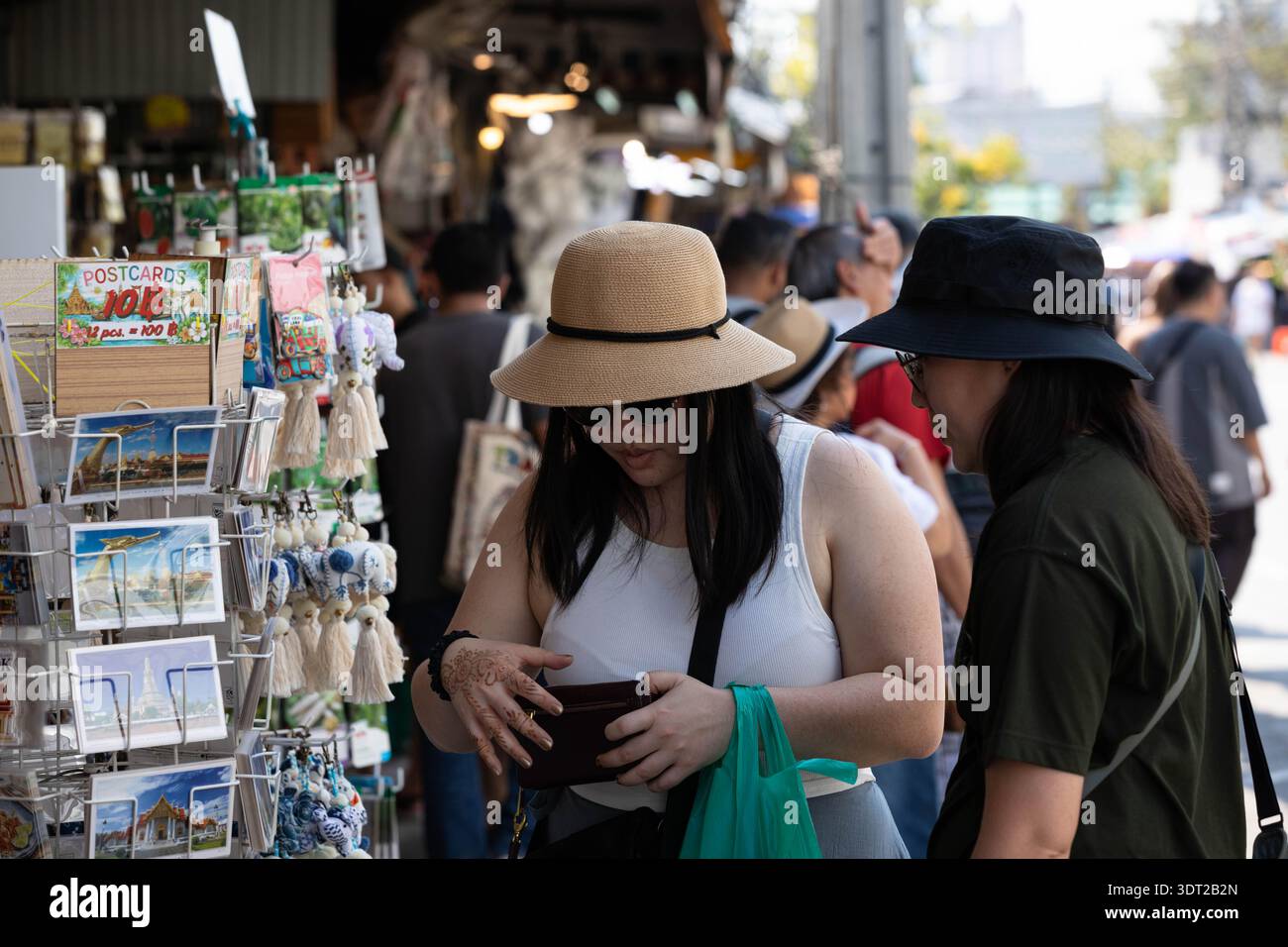 BANGKOK, THAILAND-JAN 25, 2026: Two female tourists shopping, one ...