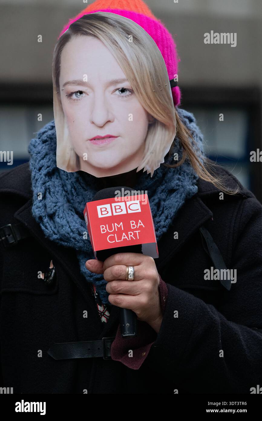 London, UK. 20 February, 2026. An activist wears a mask depicting BBC ...