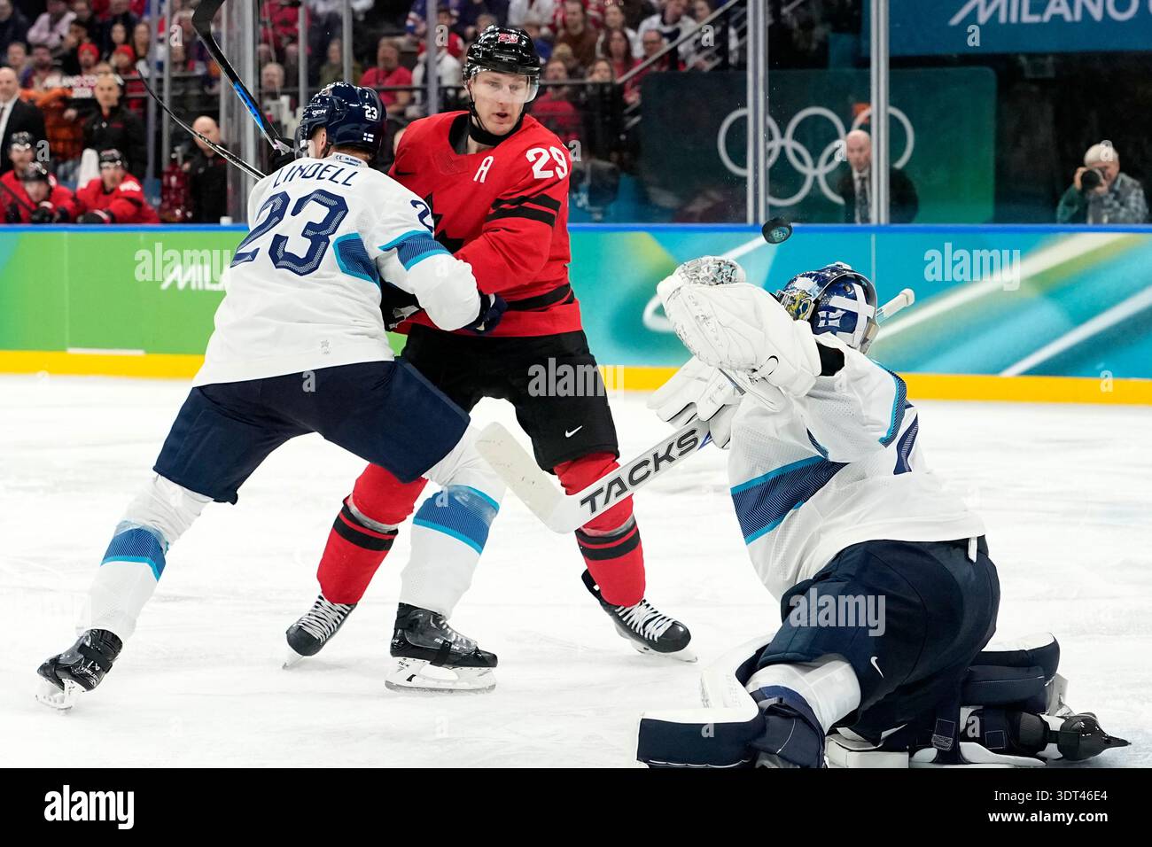 Canada's Nathan MacKinnon (29) challenges with Finland's Esa Lindell ...