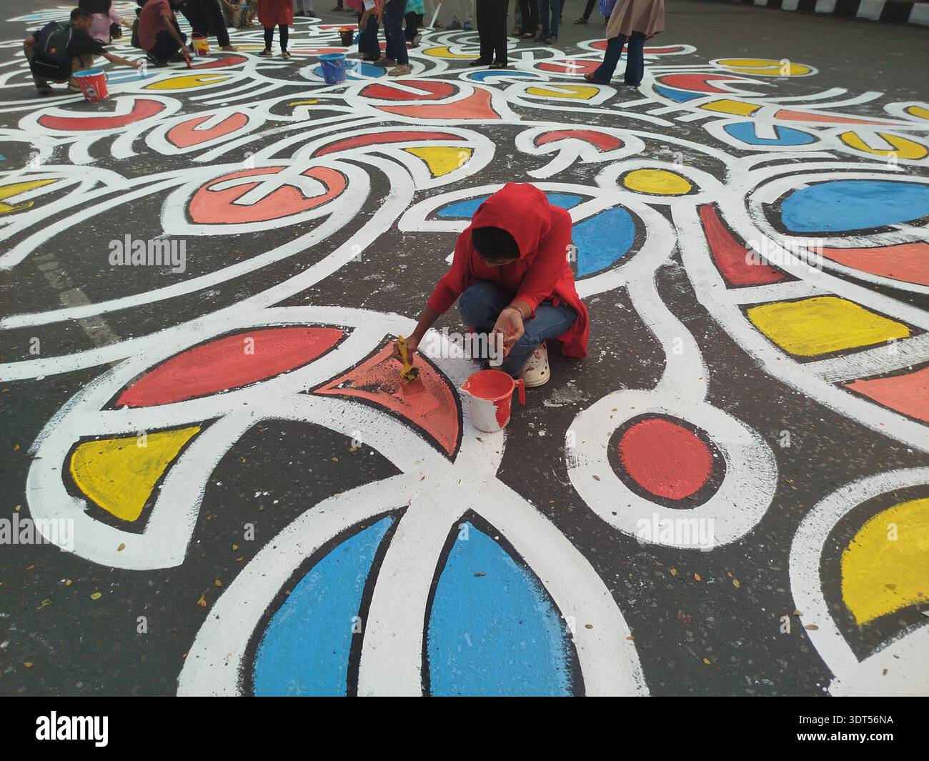 February 21, 2026, Dhaka, Bangladesh: A volunteer drew alpana motifs ...