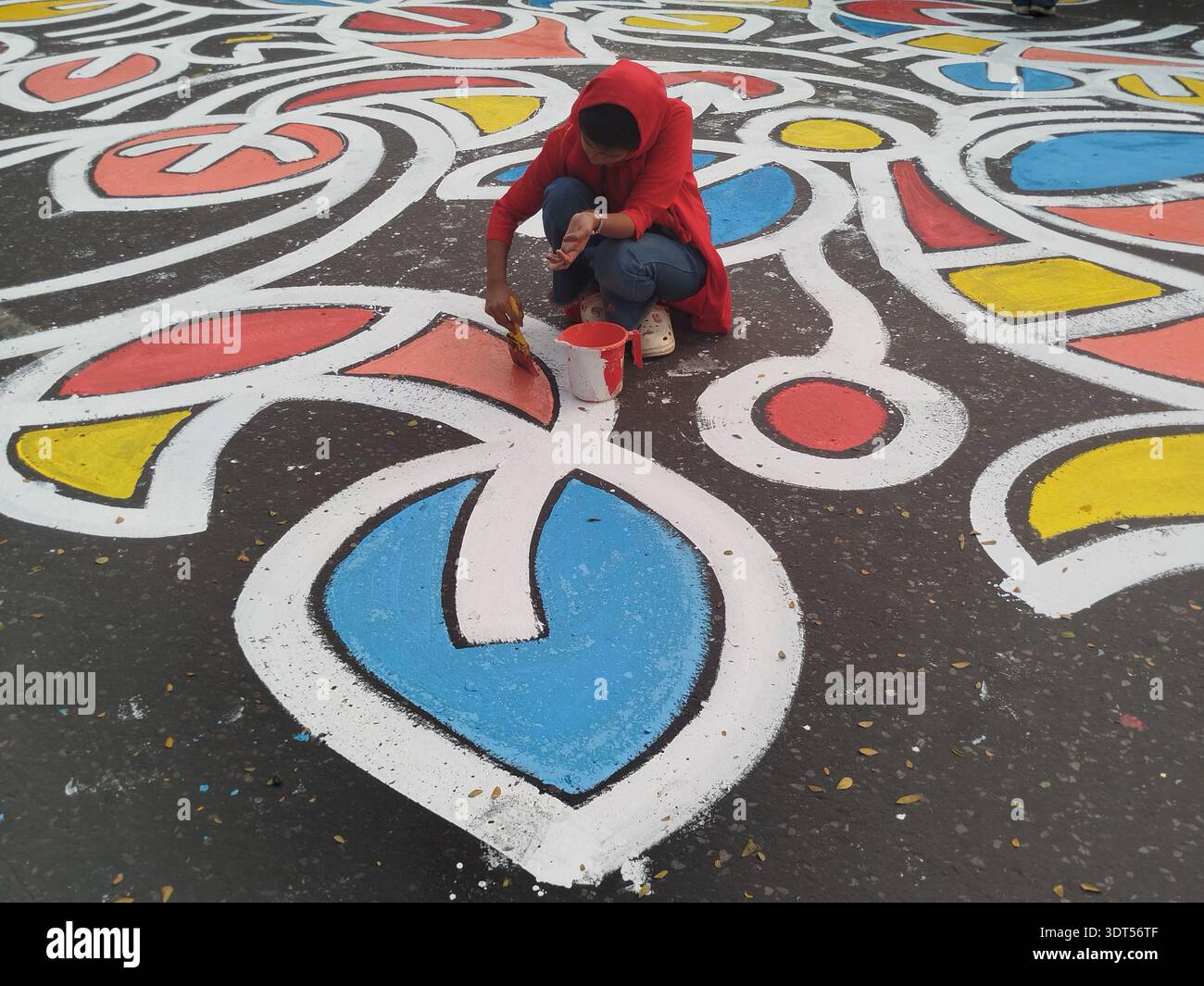 February 21, 2026, Dhaka, Bangladesh: A volunteer drew alpana motifs ...