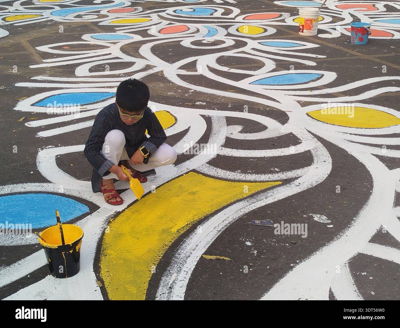 February 21, 2026, Dhaka, Bangladesh: A boy drew alpana motifs (folk ...