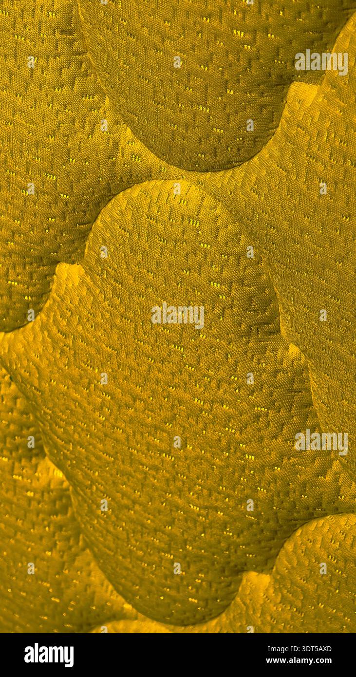 Soft golden yellow padded texture captured as an 8K wallpaper forms a ...