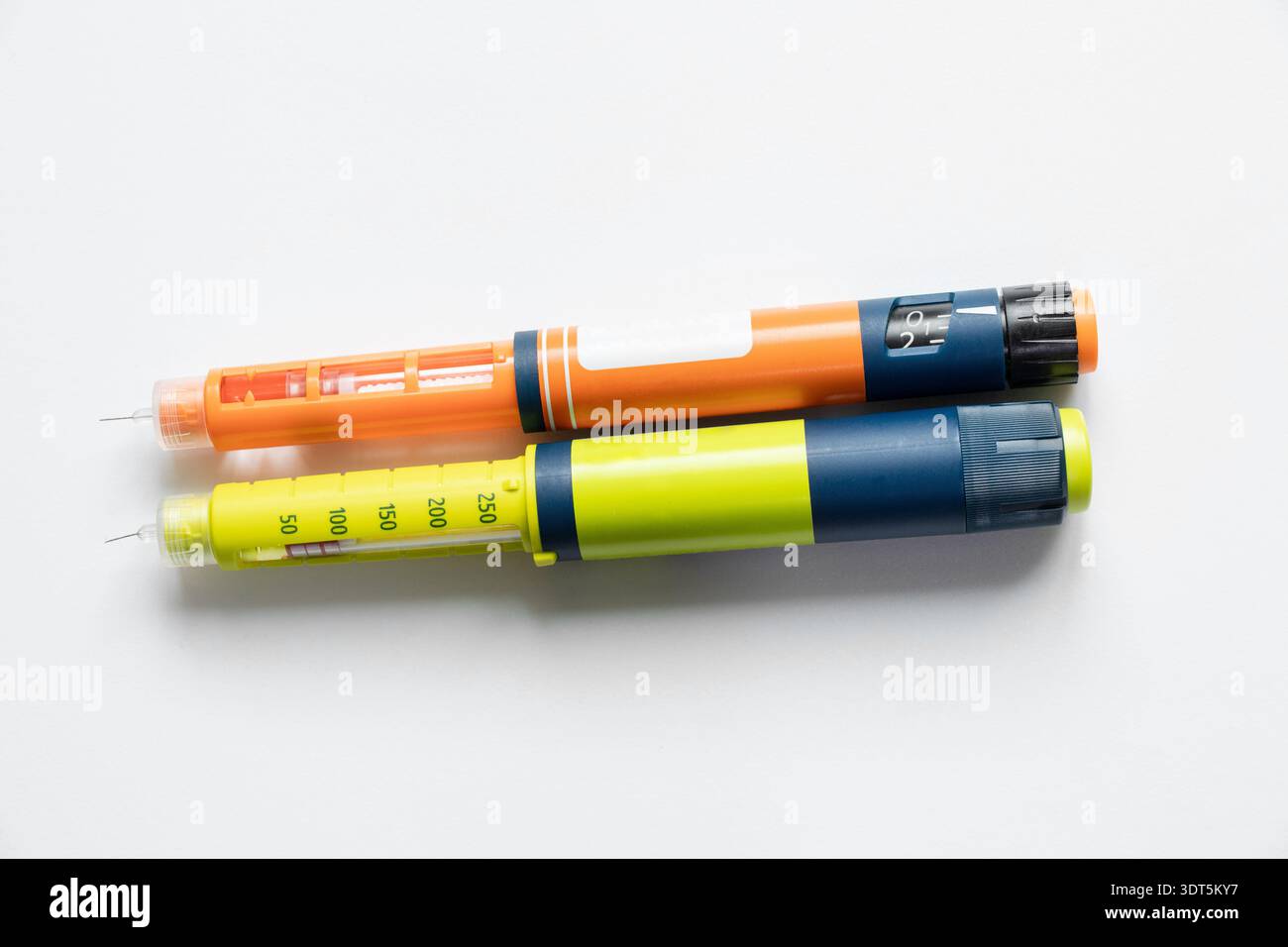 Insulin pens lying on a white background, a medical device for ...