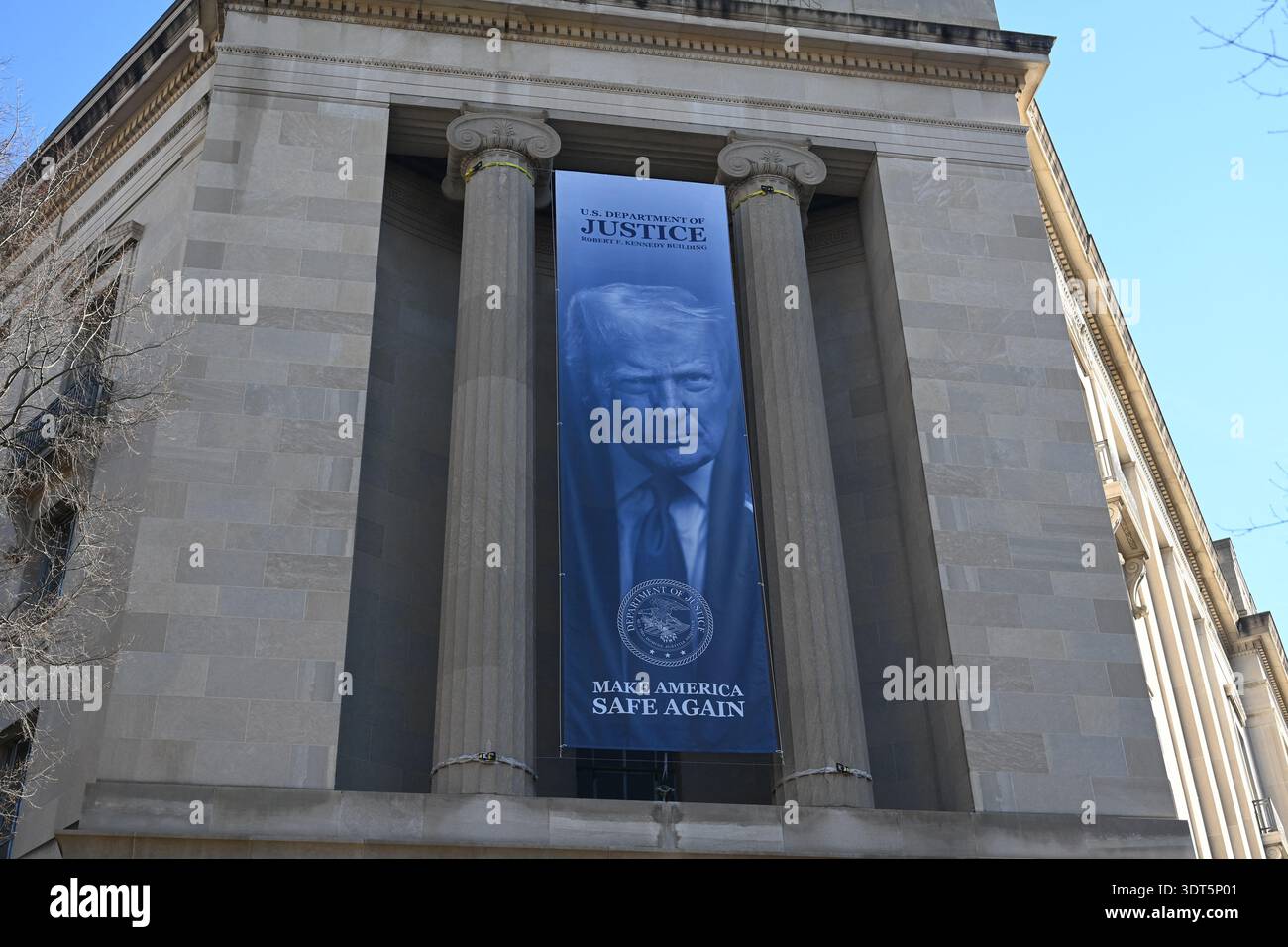 A giant banner featuring a picture of Donald Trump now hangs in front ...