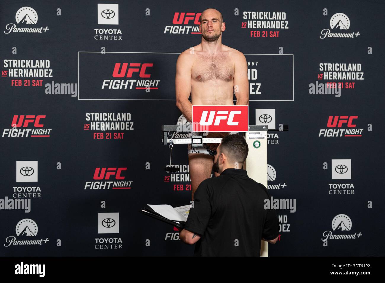 Fighter Uros Medic steps on the scale for the official weigh-in at the ...