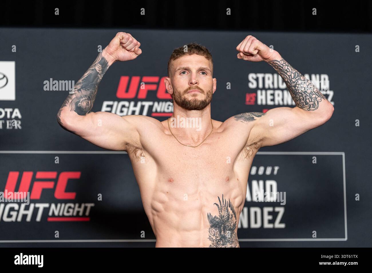 Fighter Zachary Reese steps on the scale for the official weigh-in at ...