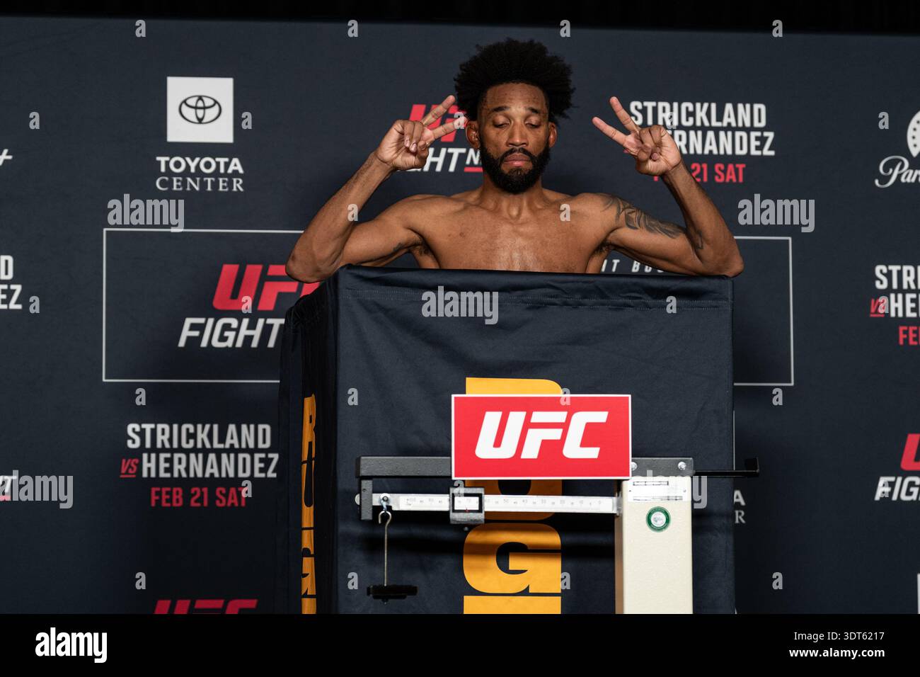 Fighter Philip Rowe steps on the scale for the official weigh-in at the ...