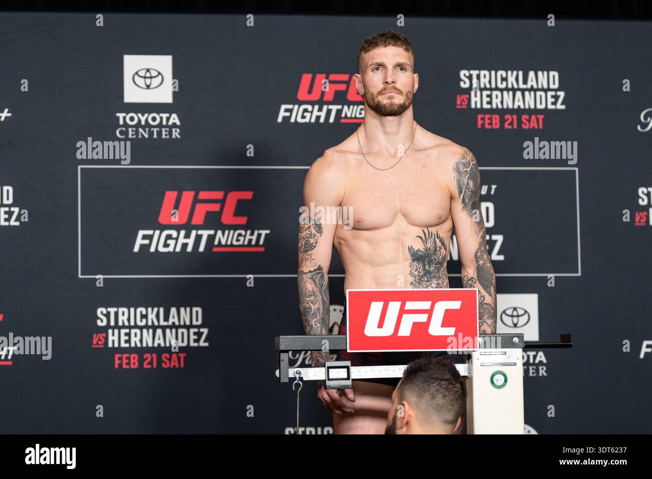 Fighter Zachary Reese steps on the scale for the official weigh-in at ...