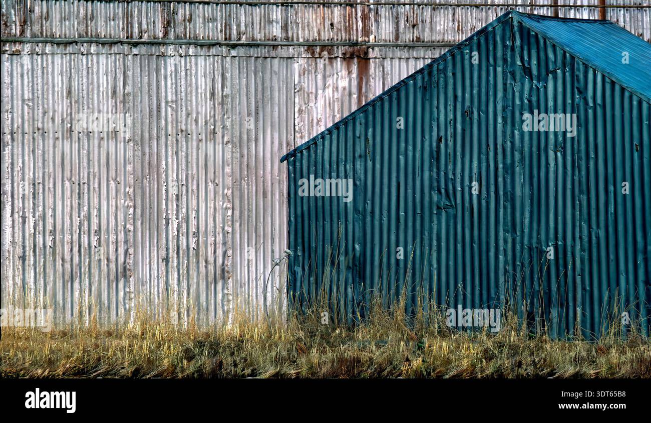 A study in vertical textures as a green metal corrugated shed sits next ...