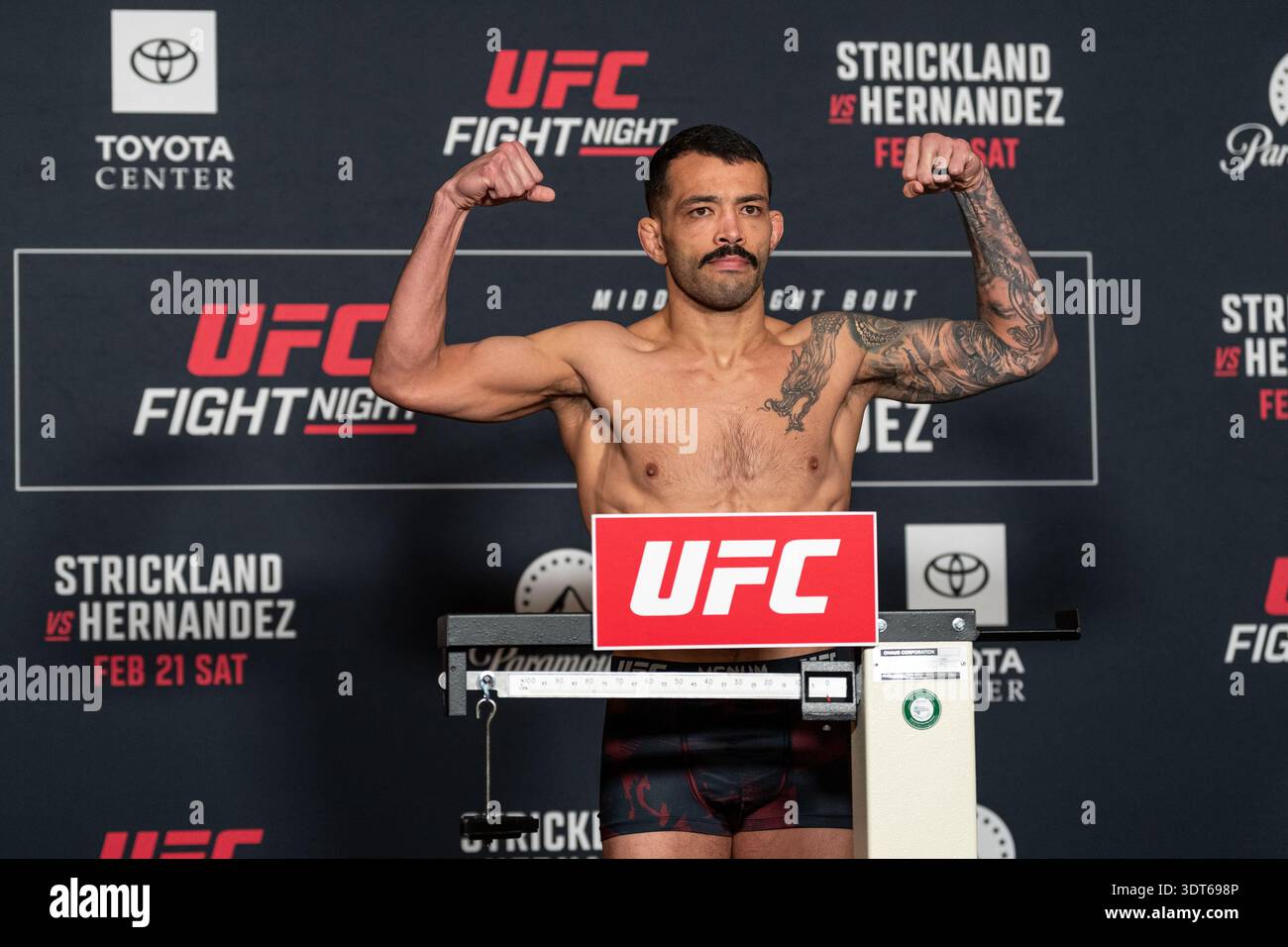 Fighter Dan Ige steps on the scale for the official weigh-in at the ...