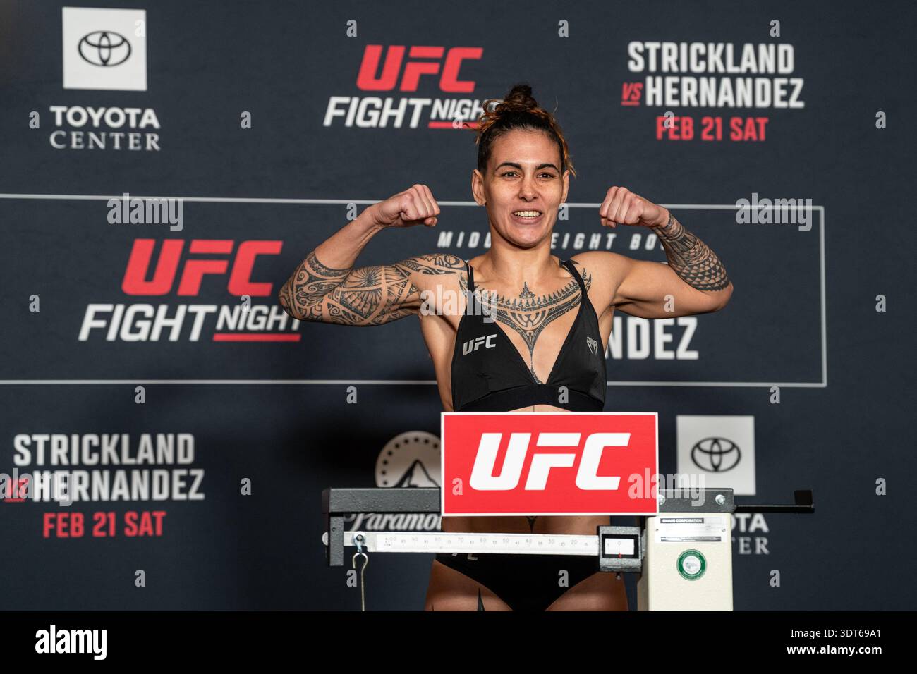 Fighter Nora Cornolle steps on the scale for the official weigh-in at ...