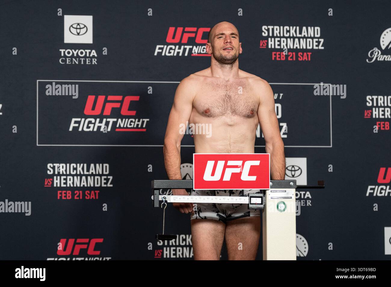 Fighter Uros Medic steps on the scale for the official weigh-in at the ...