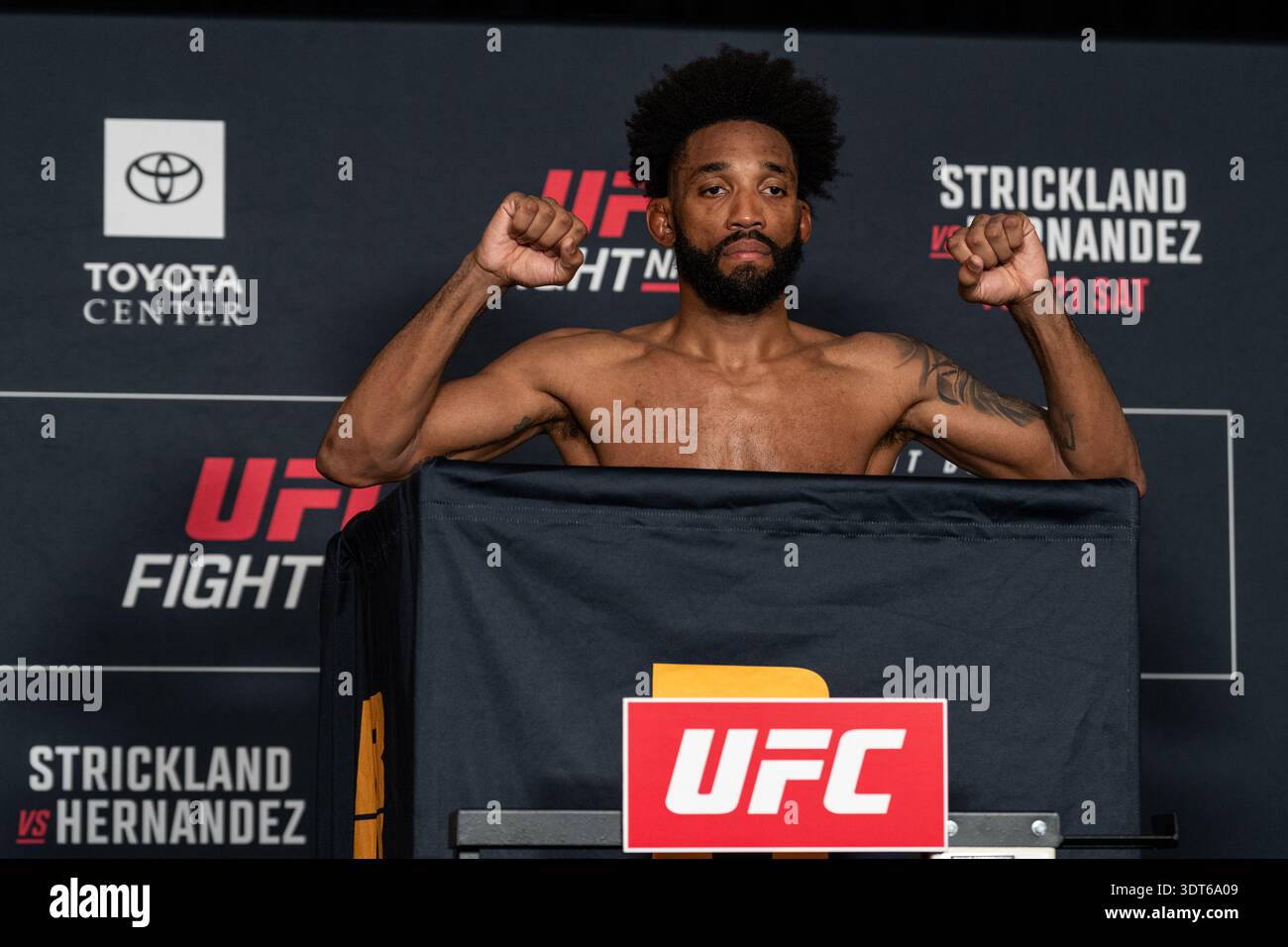 Fighter Philip Rowe steps on the scale for the official weigh-in at the ...
