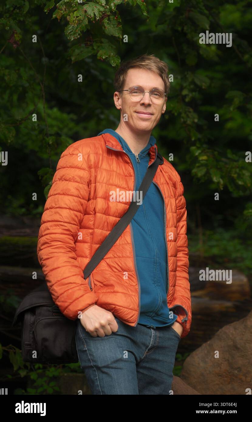 Person in orange jacket hi-res stock photography and images - Alamy