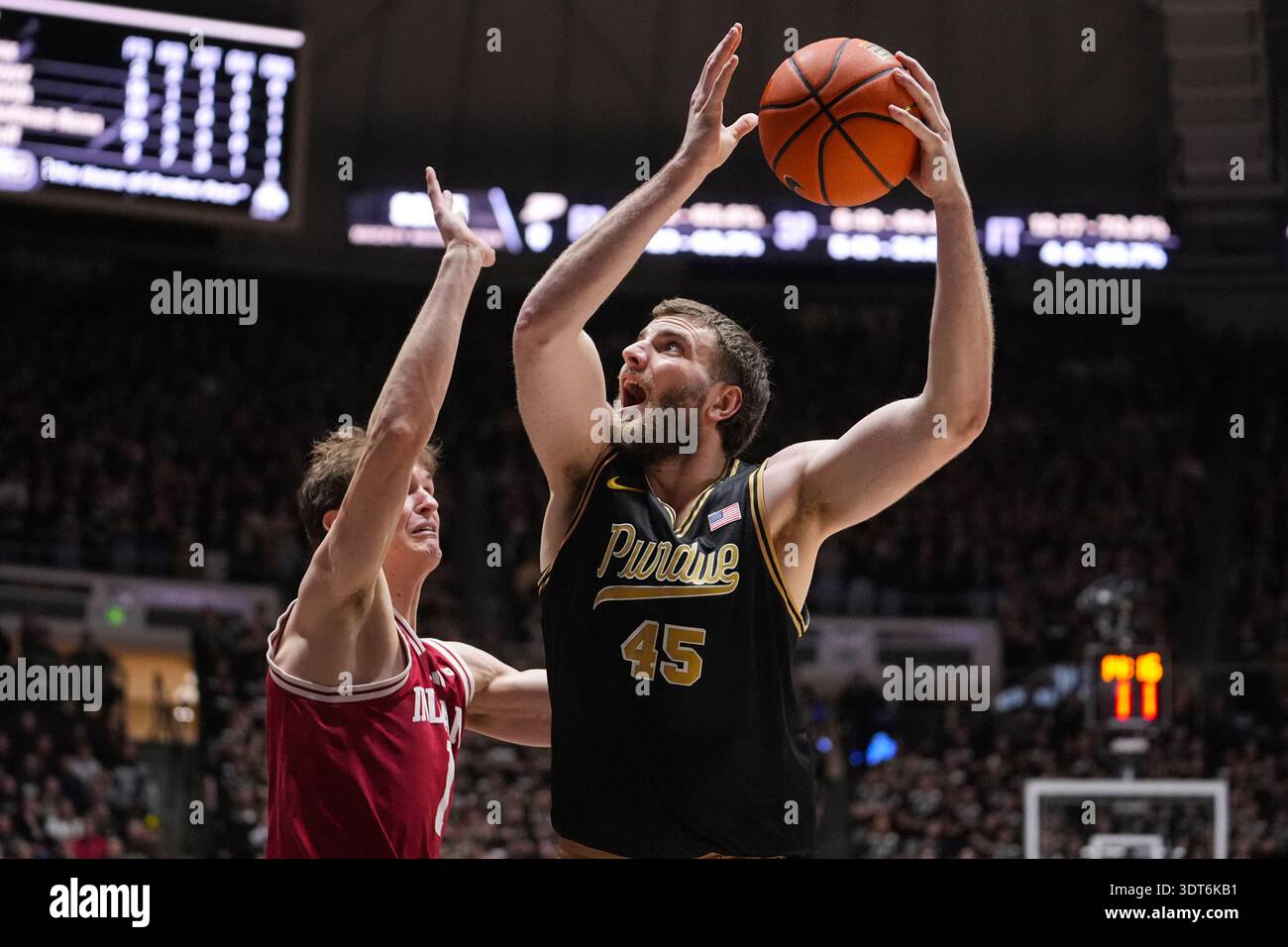 Purdue center Oscar Cluff (45) shoots over Indiana forward Reed Bailey ...