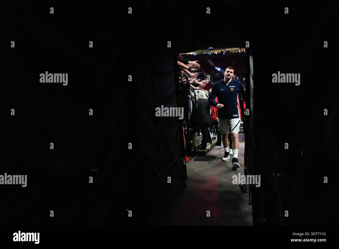 Denver Nuggets center Nikola Jokić walks past fans after an NBA ...