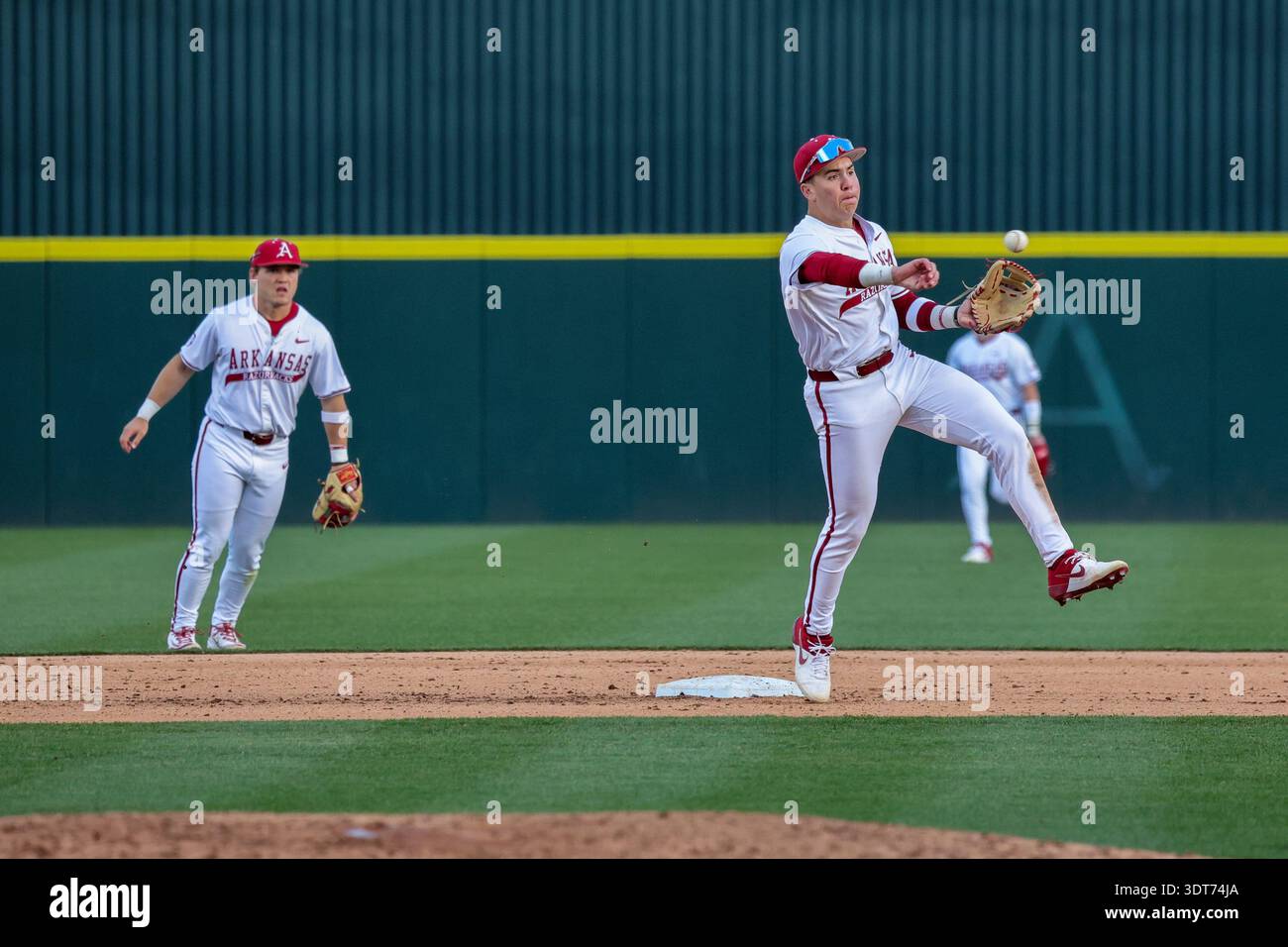 February 20, 2026: Razorback short stop Cason Barumbaugh (1) flips the ...
