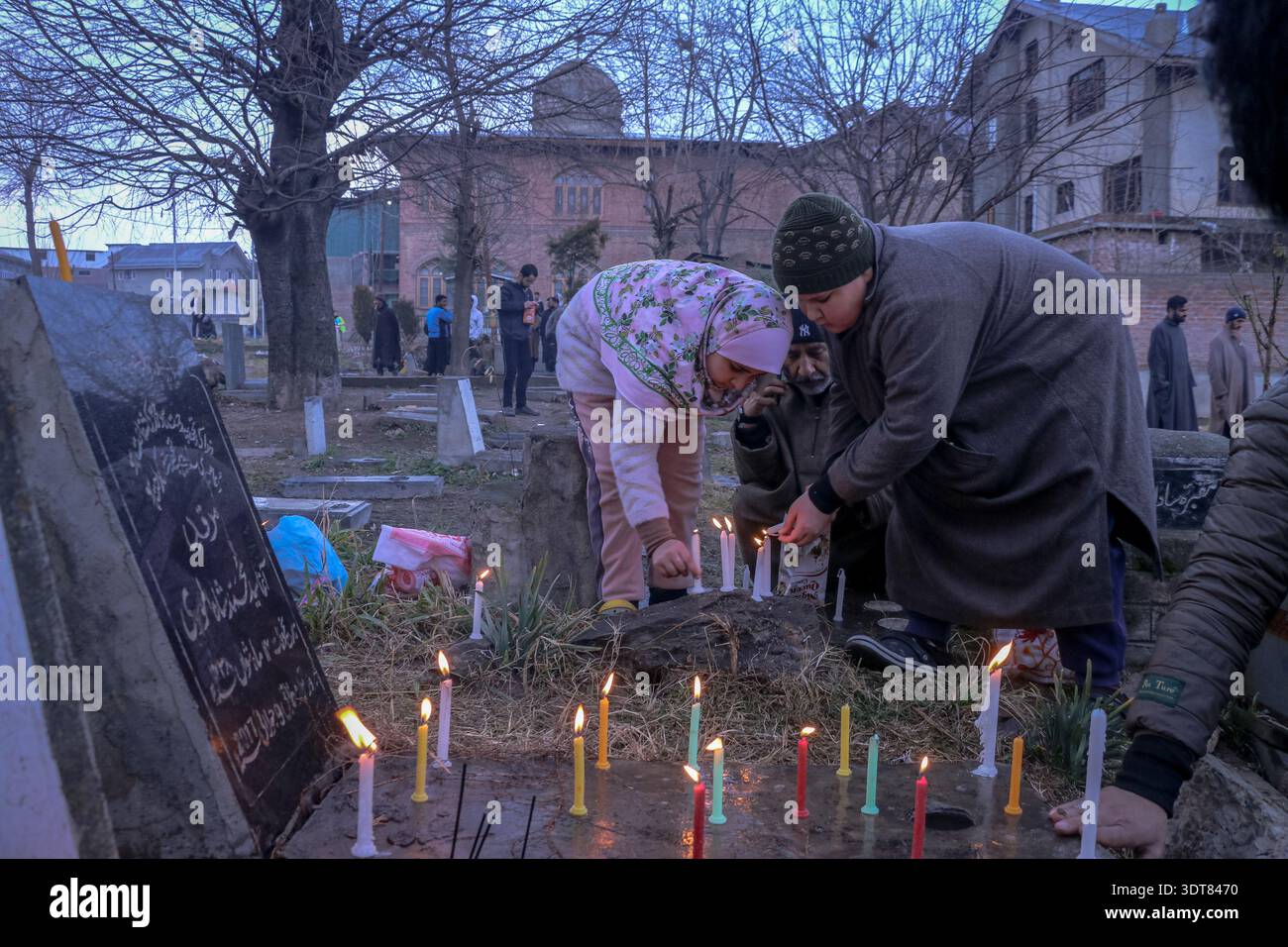 Shia Muslims light candles at a cemetery during Shab-e-Barat in ...