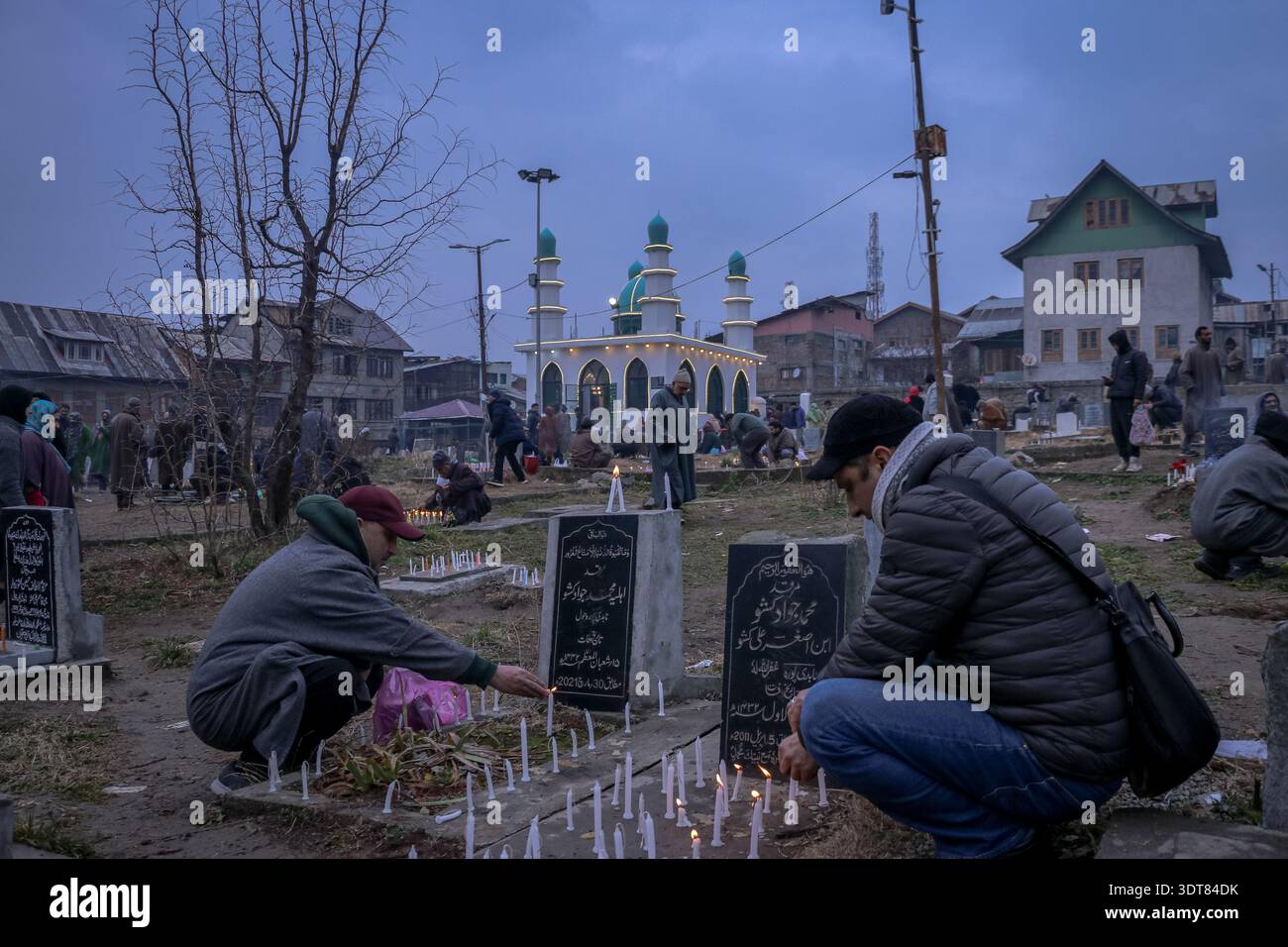 Shia Muslims light candles at a cemetery during Shab-e-Barat in ...