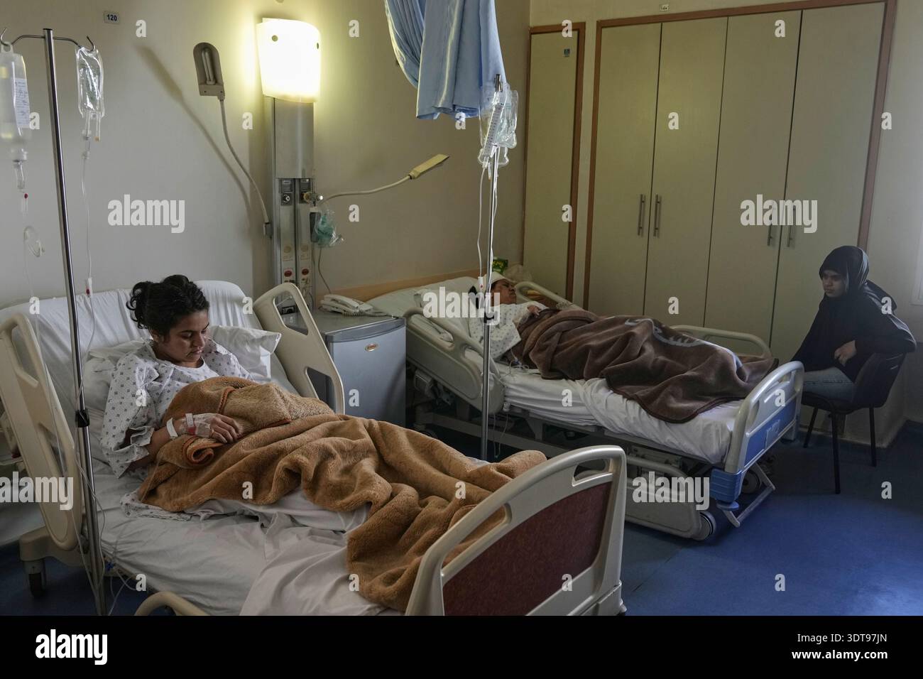 Syrian Maha al-Jassem, center, and her daughter Razan al-Jassem, left ...
