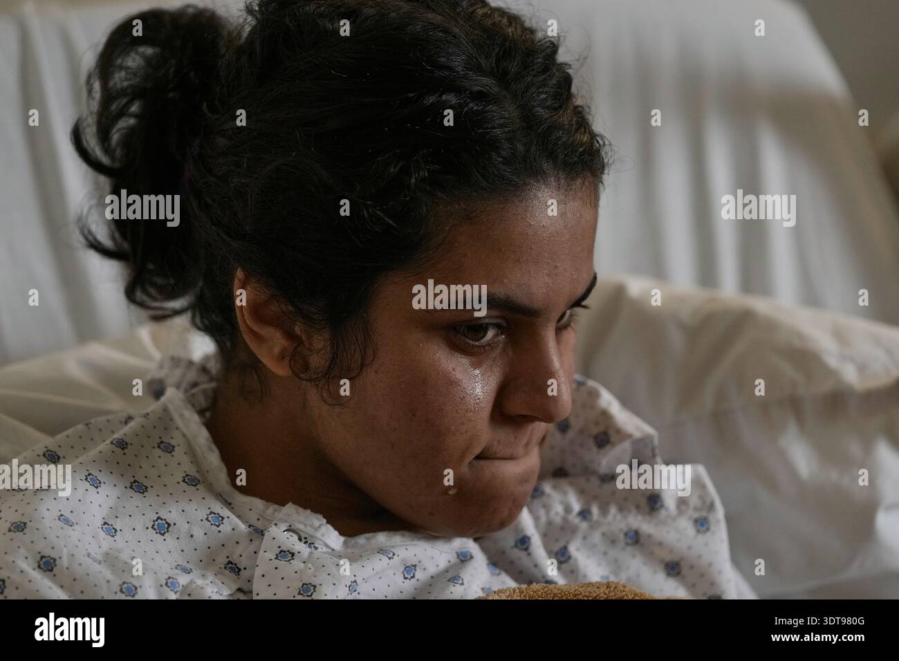Syrian Razan al-Jassem, who was wounded in an Israeli airstrike, lies ...