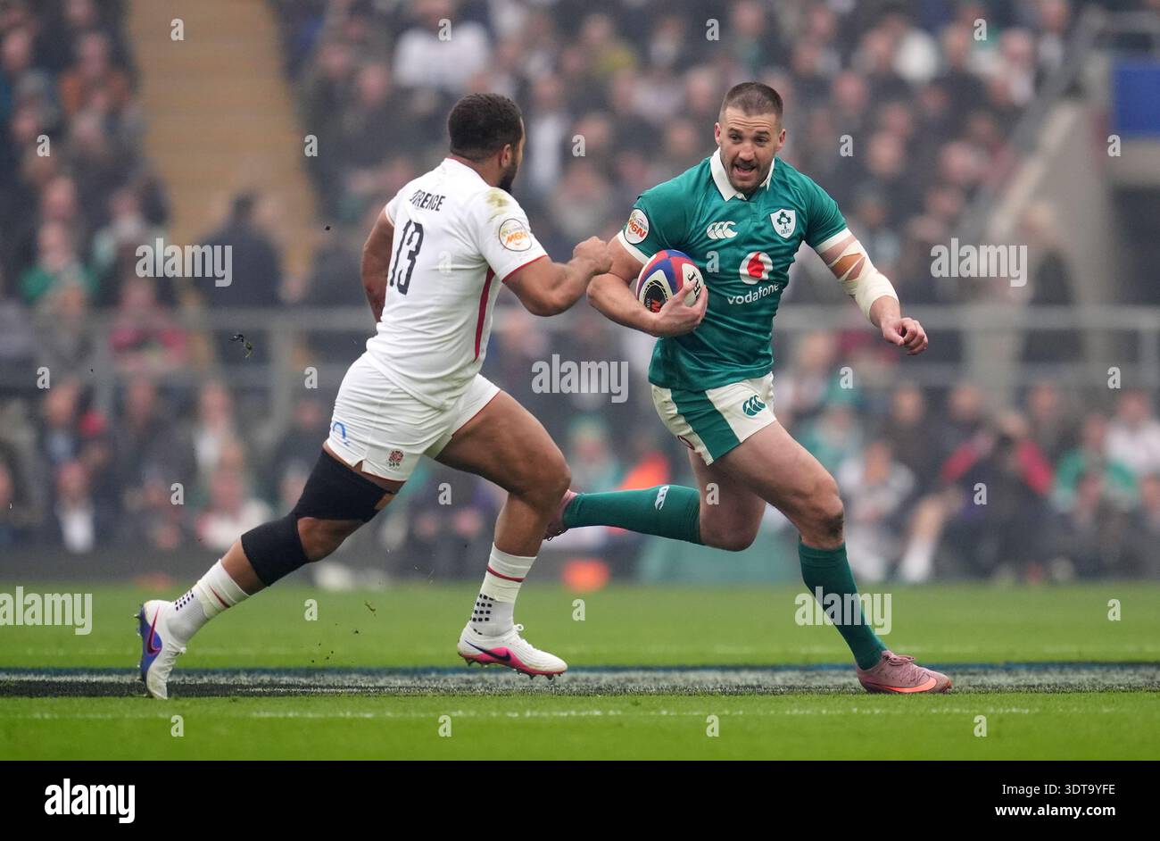 England's Ollie Lawrence and Ireland's Stuart McCloskey in action ...