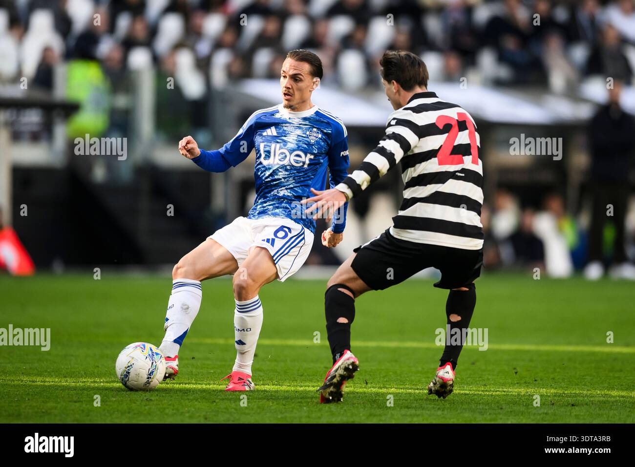 Maxence Caqueret of Como 1907 competes for the ball with Fabio Miretti ...